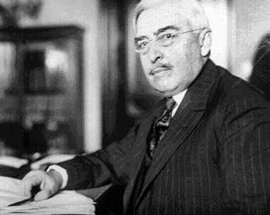 William M. Butler pictured in 1924 wearing formal attire and writing,