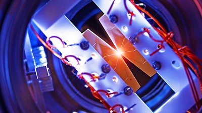 An ion trap with four segmented blade electrodes used to trap a linear ...