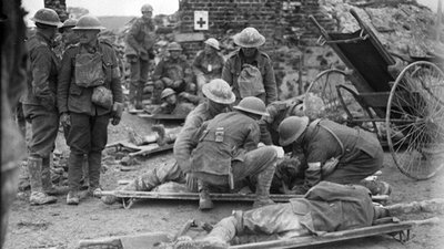 Other men giving attention to wounded soldiers.