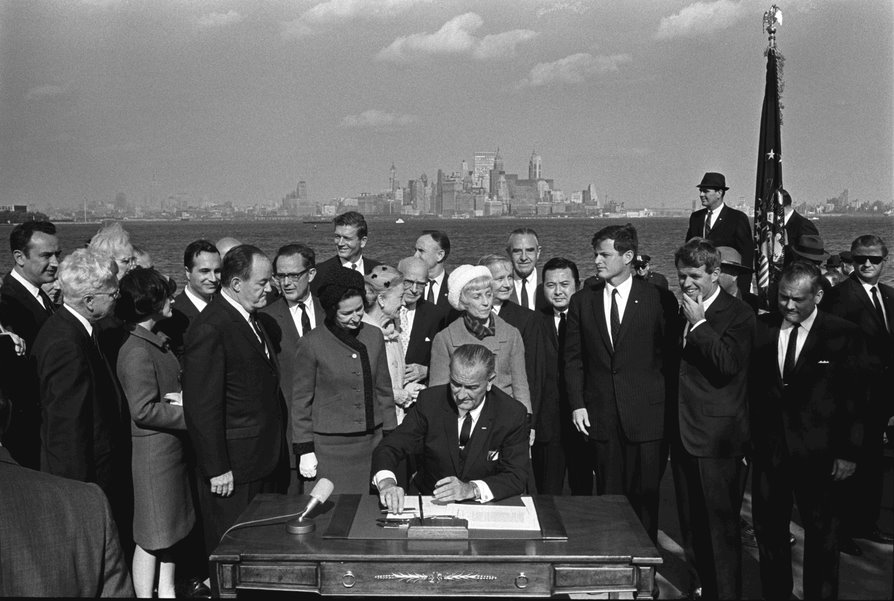 President Lyndon Johnson signs the Immigration and Nationality Act of 1965.