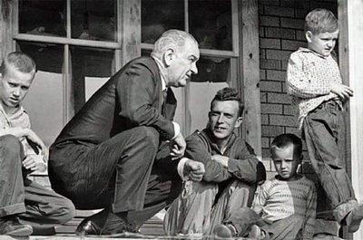 President Lyndon Johnson, on the porch of Tom Fletcher's cabin, listens ...