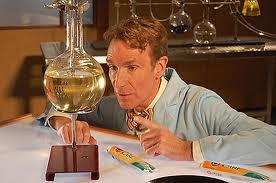 A picture of Bill Nye doing an experiment.
