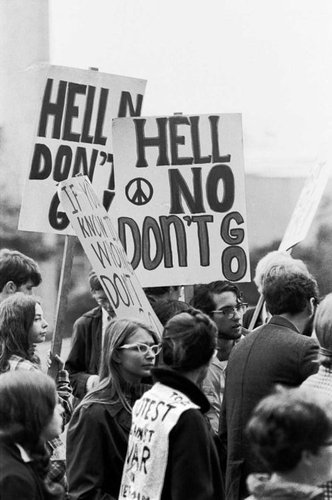 This image shows protesters holding up signs to protest the Vietnam War.