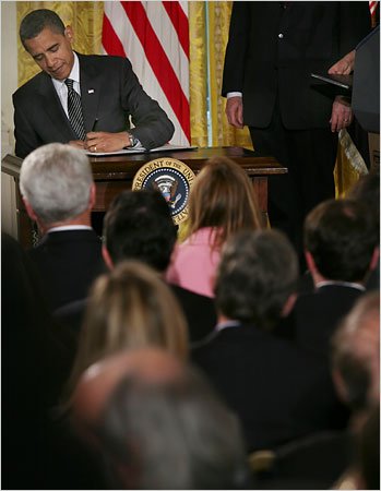 Obama signing the presidential memorandum. From The New York Times ...