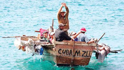 This is a picture of some Cuban men traveling in a small boat with a ...