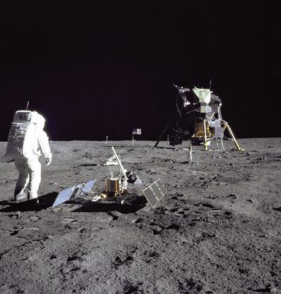 Buzz Aldrin next to the first seismometer on the moon