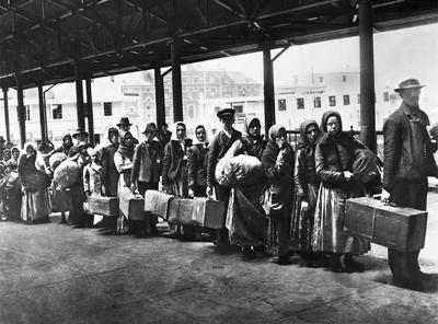 Immigrants standing in a queue on Ellis Island.