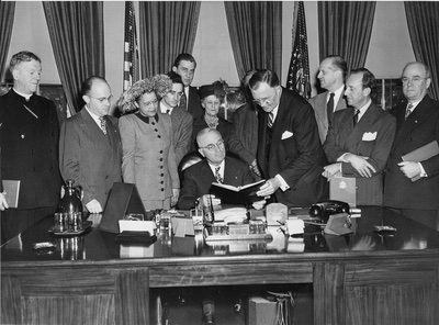 Truman receiving a Commission on Civil Rights Report