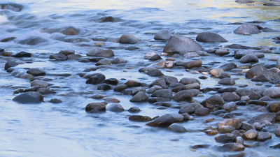 The rocks on the bottom of this riverbed weren't always this smooth ...