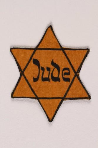 2005.579.5 front Star of David yellow cloth patch with Jude printed in ...