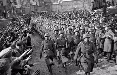 Nazi forces marching through the streets of Prague, the capital of ...