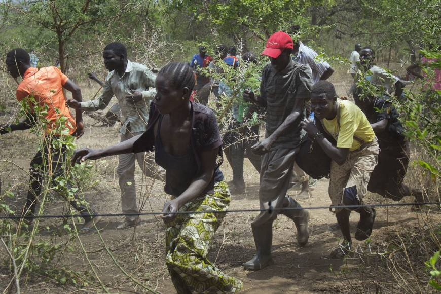 Boys running into the bush