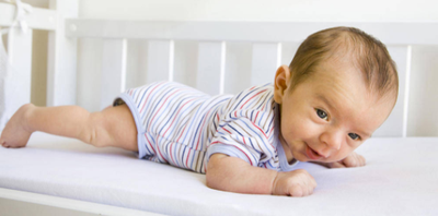 This baby is in prone position and slightly lifting it's head.