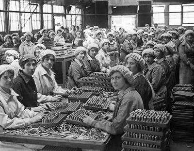 This picture shows women working at a munition factory making cartridges.
