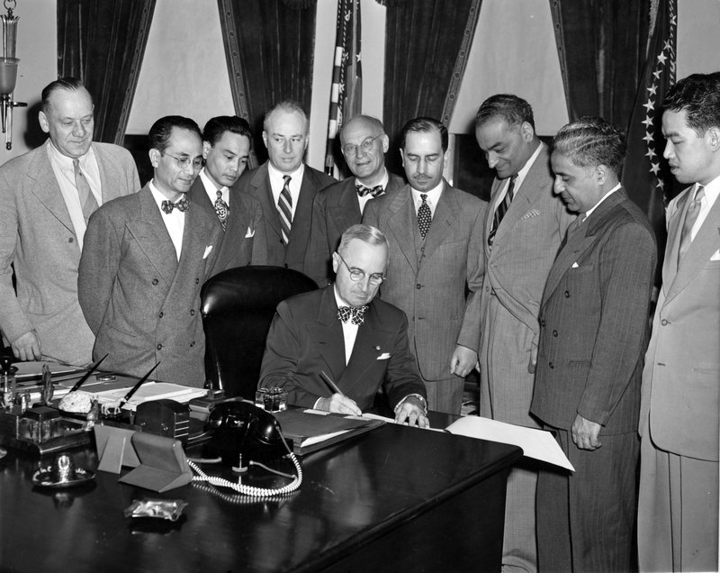Truman signs the Luce-Celler Act in 1946.