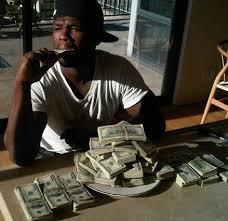 50 cent with a table full of money.
