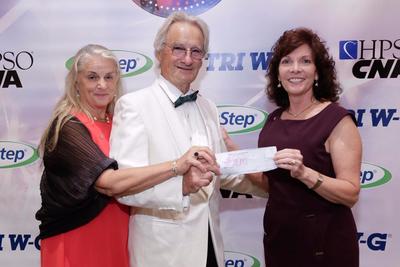 Catherina Patla and Stanley Paris present a check to Edee Field-Fote at ...