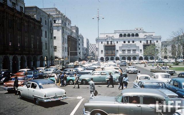 Plaza de Armas in 1960, lots of cars around, implying that the city has ...