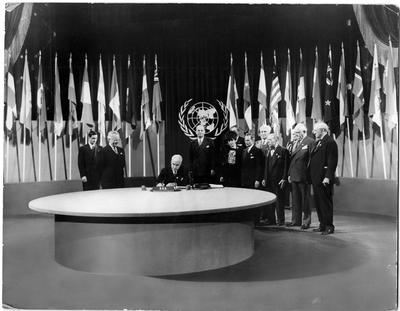 “The Signing of the United Nations charter by Stettinius as Truman ...