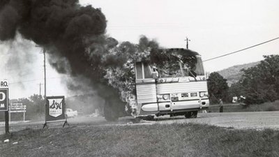 One bus being burned by KKK members during the protest.