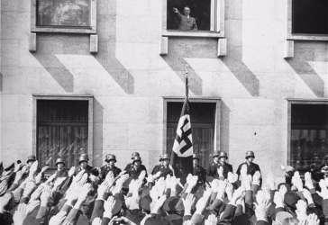 Hitler greeting a crowd of enthusiastic Germans from a window of the ...