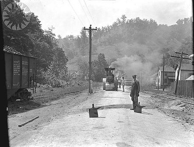 A road being constructed with macadam, or broken stone. https://en ...