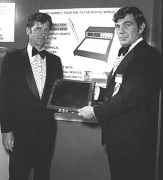 This image shows George Hurst, on the left, holding the Elotouch.