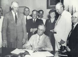 President Franklin D. Roosevelt signing the social security act of 1935.