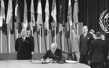 President Truman signs United Nations charter.