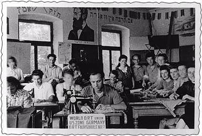 Sher teaching the girls to sew