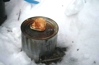 Fire cake on a bucket with a snowy background at Valley Forge.
