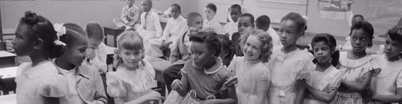 african-american and white school children play happily together