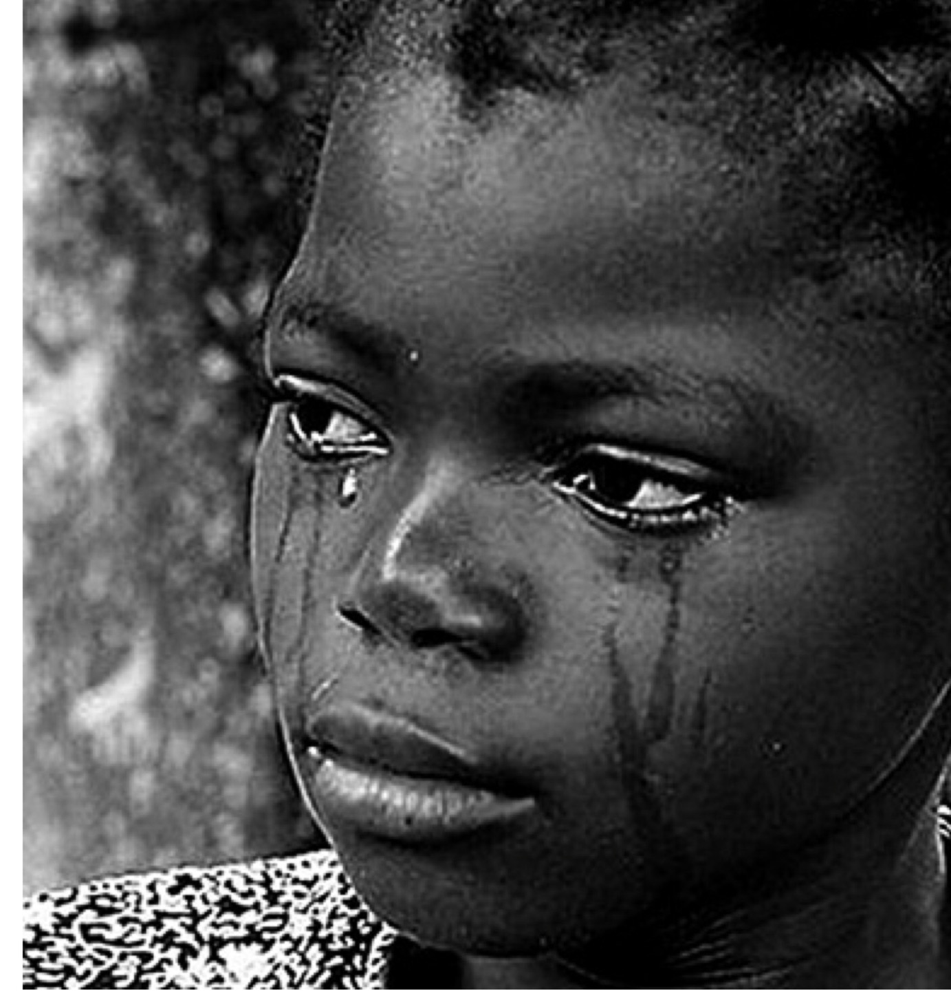 This is an image of a Sudanese refugee boy crying.