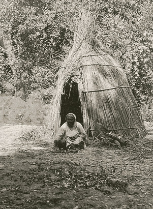 A women sitting in front of her Reed house