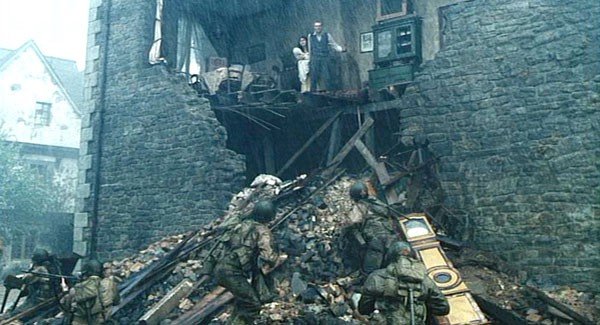 Captain Miller's squad interacting with a stranded French family.