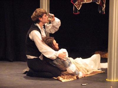 Romeo drinks the poison next to Juliet's seemingly dead body.