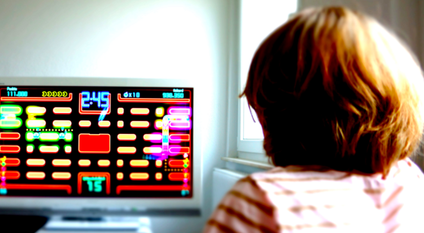Girl playing PacMan. https://upload.wikimedia.org/wikipedia/commons/c ...