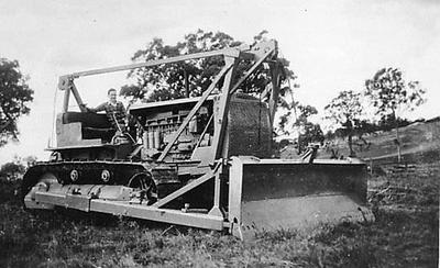An image of a Bulldozer blade attached to a tractor.