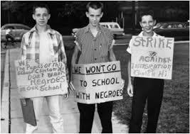 Three white boys protesting racial integration.