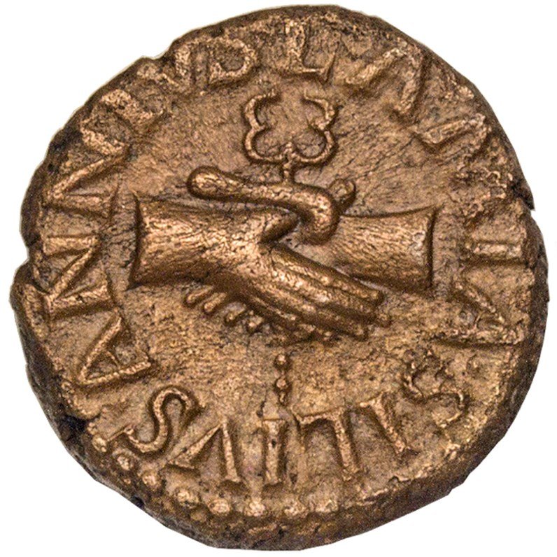 This is a coin with a picture of two people shaking hands, showing peace.