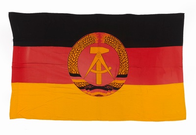 A GDR flag from October 1974.German flag on background (yellow, red and ...