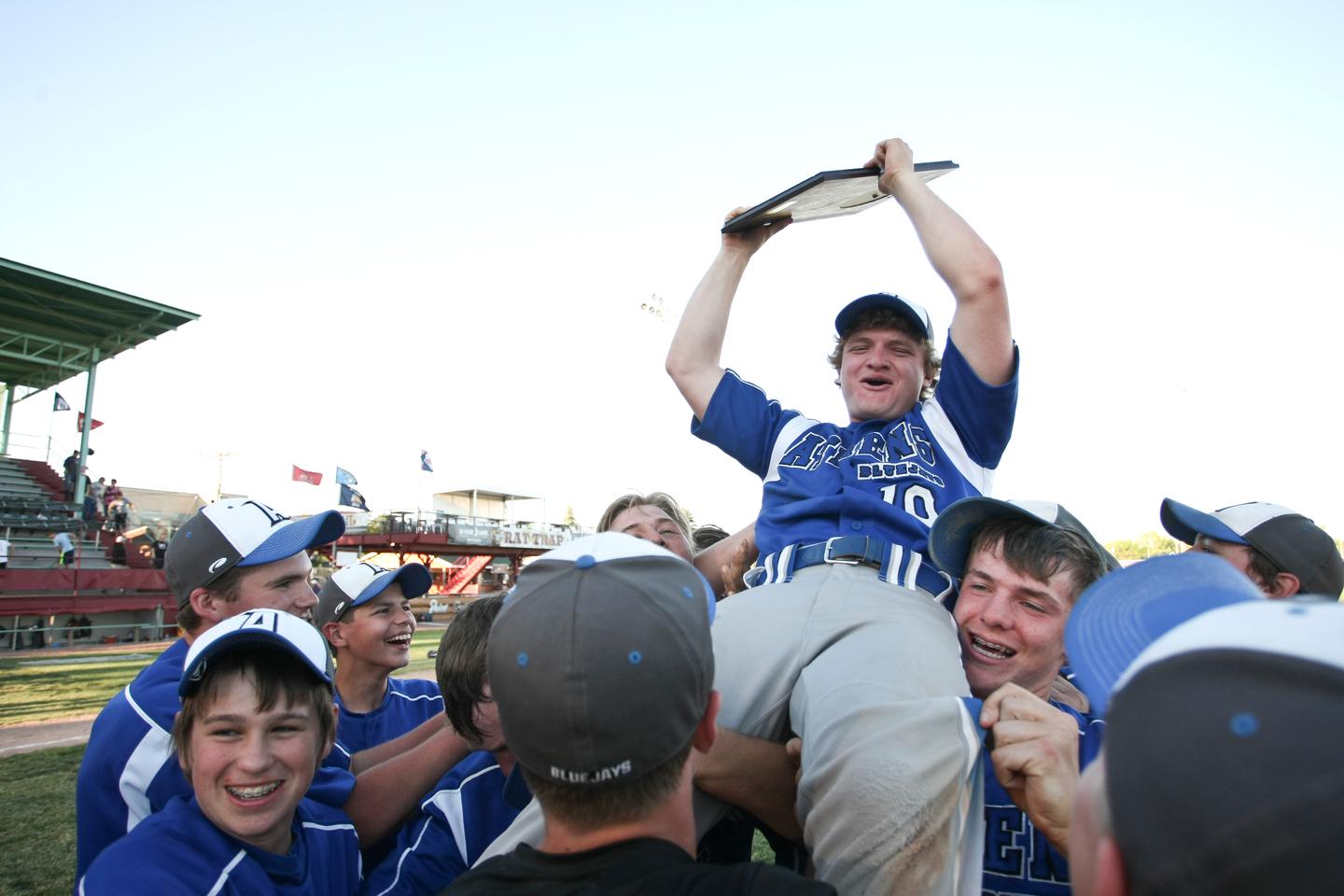 Athens' Jake Stange hoists the sectional plaque after the Bluejays beat ...