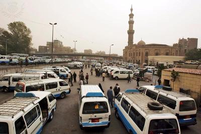 Photograph I found of a large cluster of buses around a public square ...