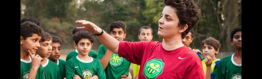 The woman in red is Coach Luma.