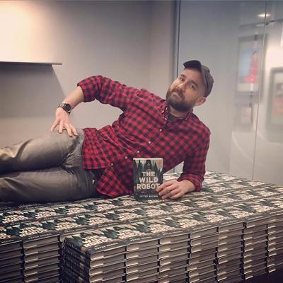 Peter with his first chapter book, The Wild Robot.