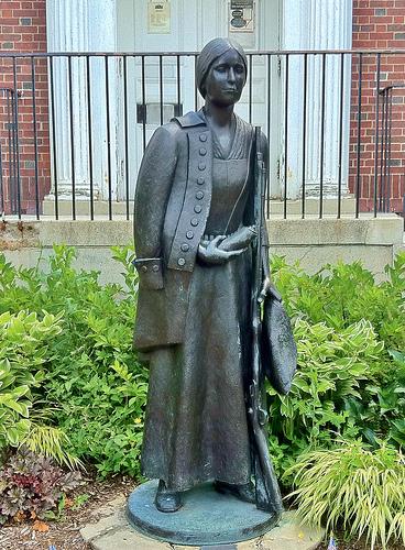 Statue of Deborah Sampson wearing a soldier's uniform and carrying a ...