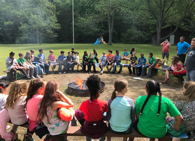 We meet every morning and evening for a team meeting around the campfire.