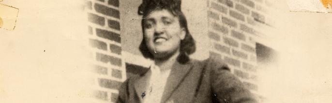 A signature picture of Henrietta: Smiling, with hands on her hips.