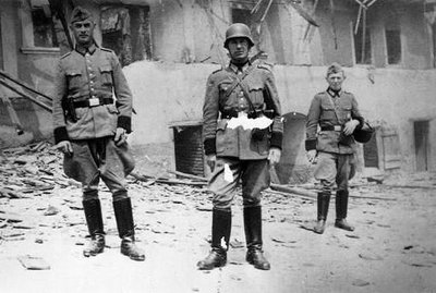 Nazi soldiers standing in the town evaluating their destruction of Lidice.